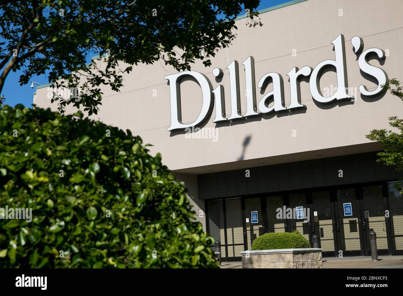 A logo sign outside of a Dillard's retail store location in Newport ...