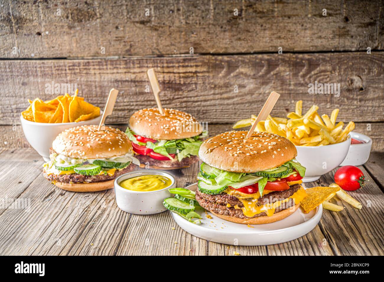 Homemade burgers on wooden background Stock Photo - Alamy