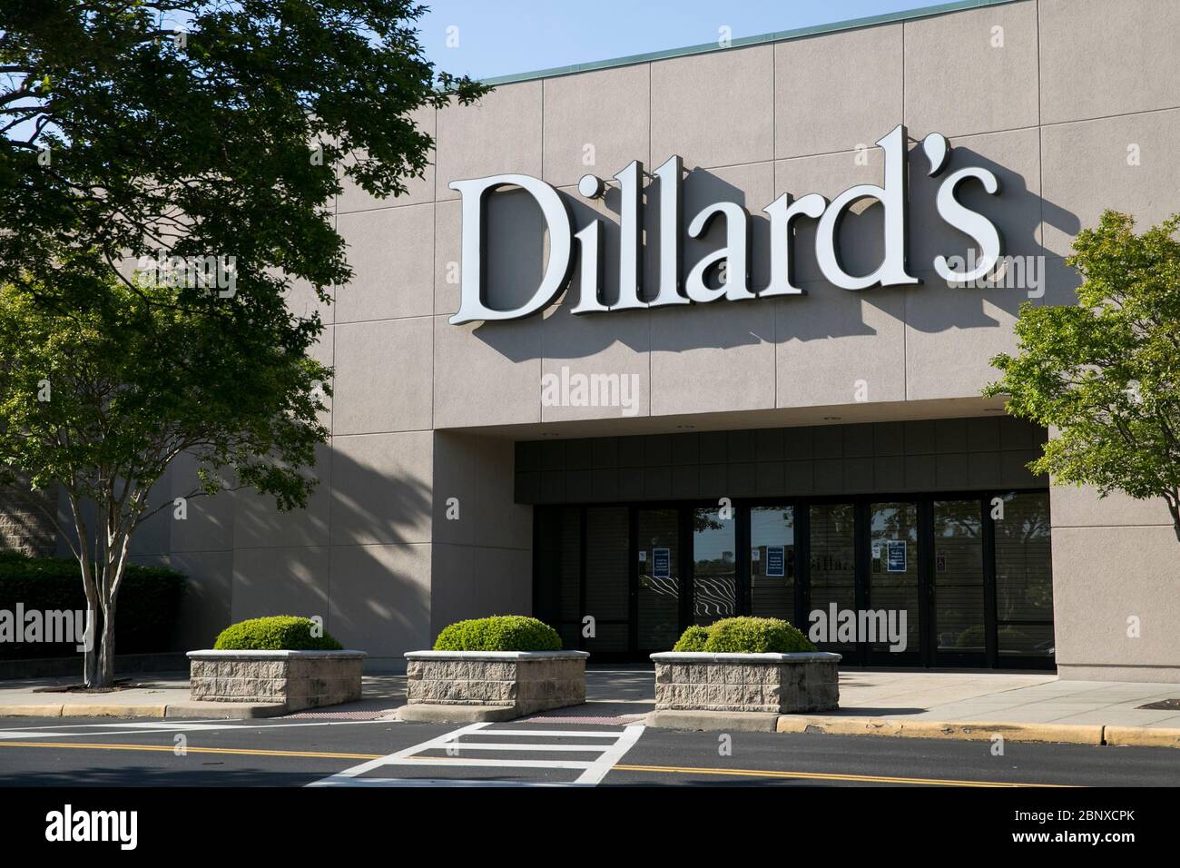 A logo sign outside of a Dillard's retail store location in Newport ...