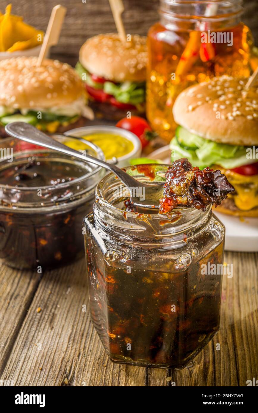 Homemade bacon jam in jars, with bread and burgers Stock Photo - Alamy