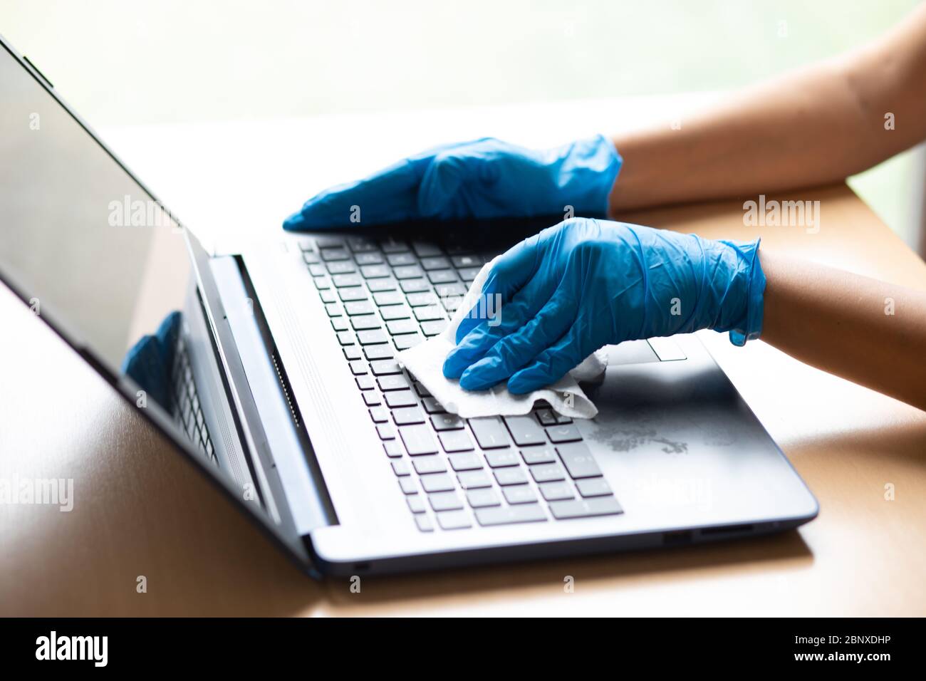 Work from home safe, cleaning and disinfecting laptop computer with wet ...