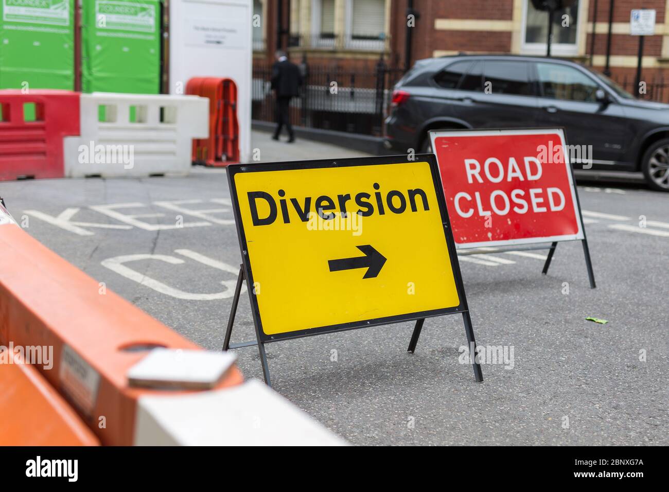 Yellow Road Sign with Arrow: Diversion Text and Barrier Stock Photo - Alamy