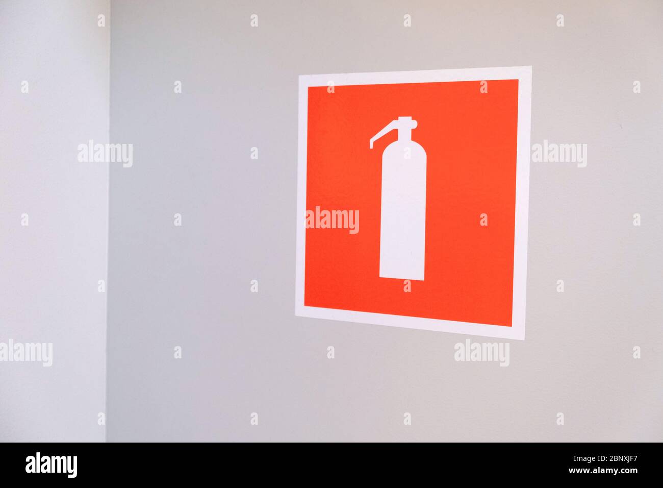 Red and white sign indicating fire hydrant on wall Stock Photo - Alamy