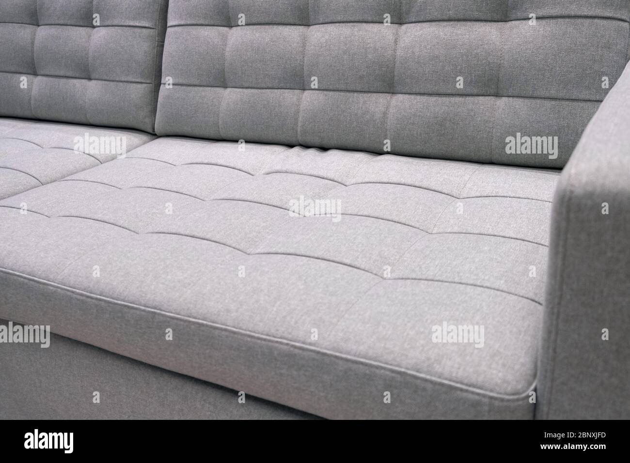 Grey textile modern sofa front view. Close up Stock Photo - Alamy