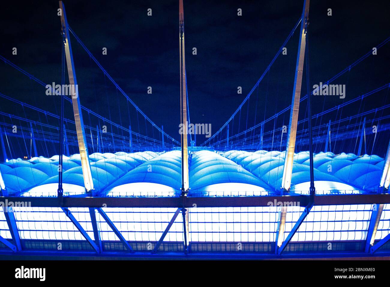 The top of an architectural building glowing in blue lights Stock Photo ...