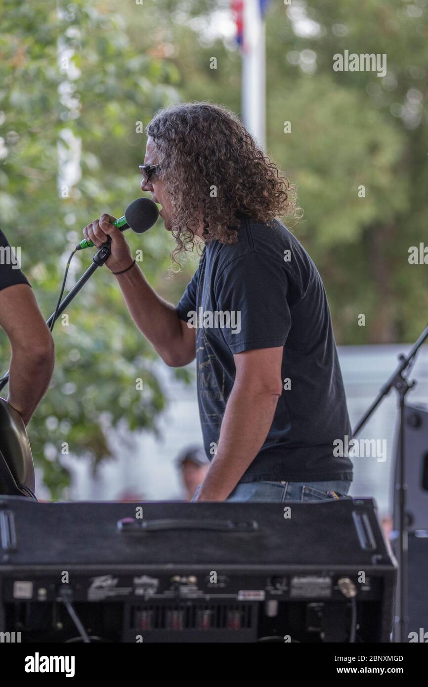 Lead singer, in rock band, performing at outdoor concert Stock Photo ...
