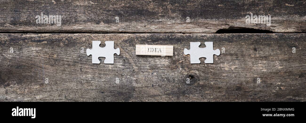 Wide view image of word Idea written on wooden peg in between two blank ...