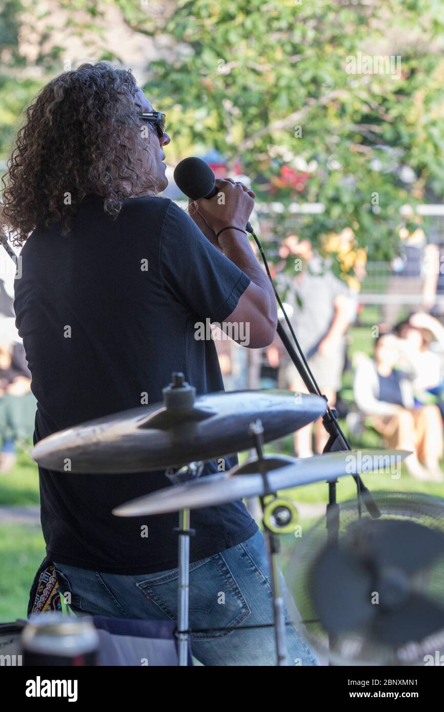 Lead singer, in rock band, performing at outdoor concert Stock Photo ...