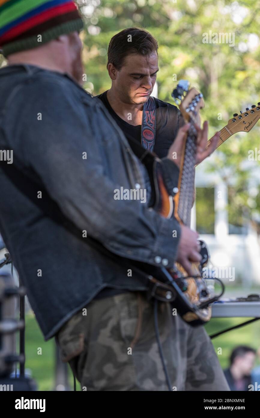 Bass player, in rock and roll band, performing at outdoor concert Stock ...