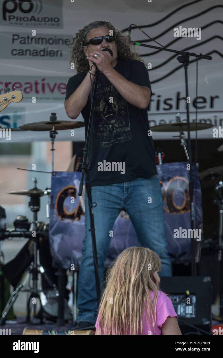 Lead singer, in rock band, performing at outdoor concert Stock Photo ...