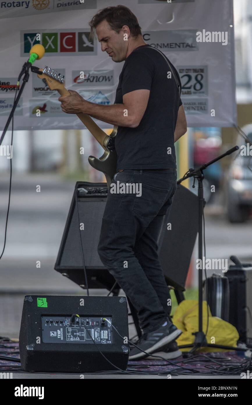 Rock and roll band's lead guitar, performing at outdoor concert Stock ...