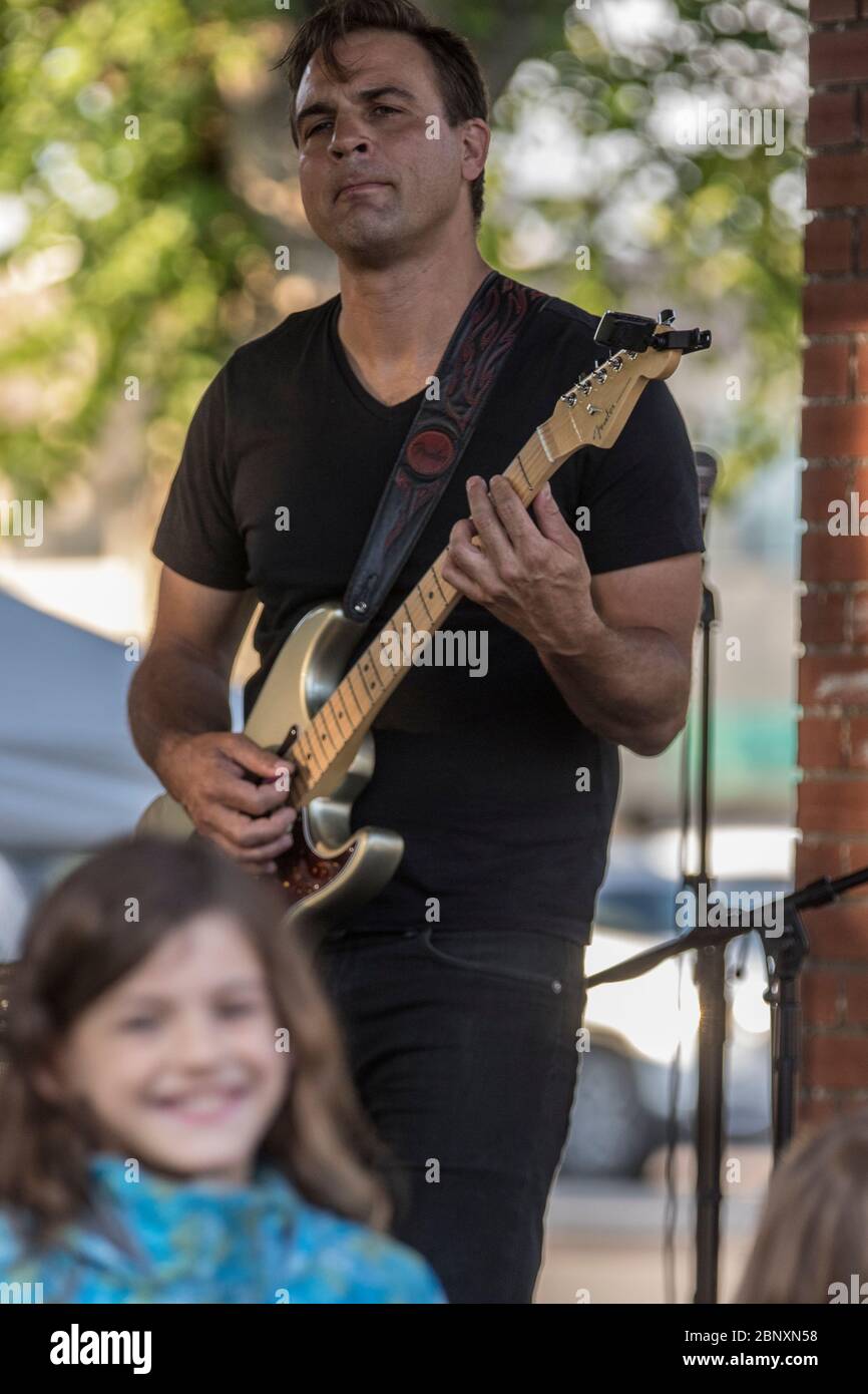 Rock and roll band's lead guitar, performing at outdoor concert Stock ...