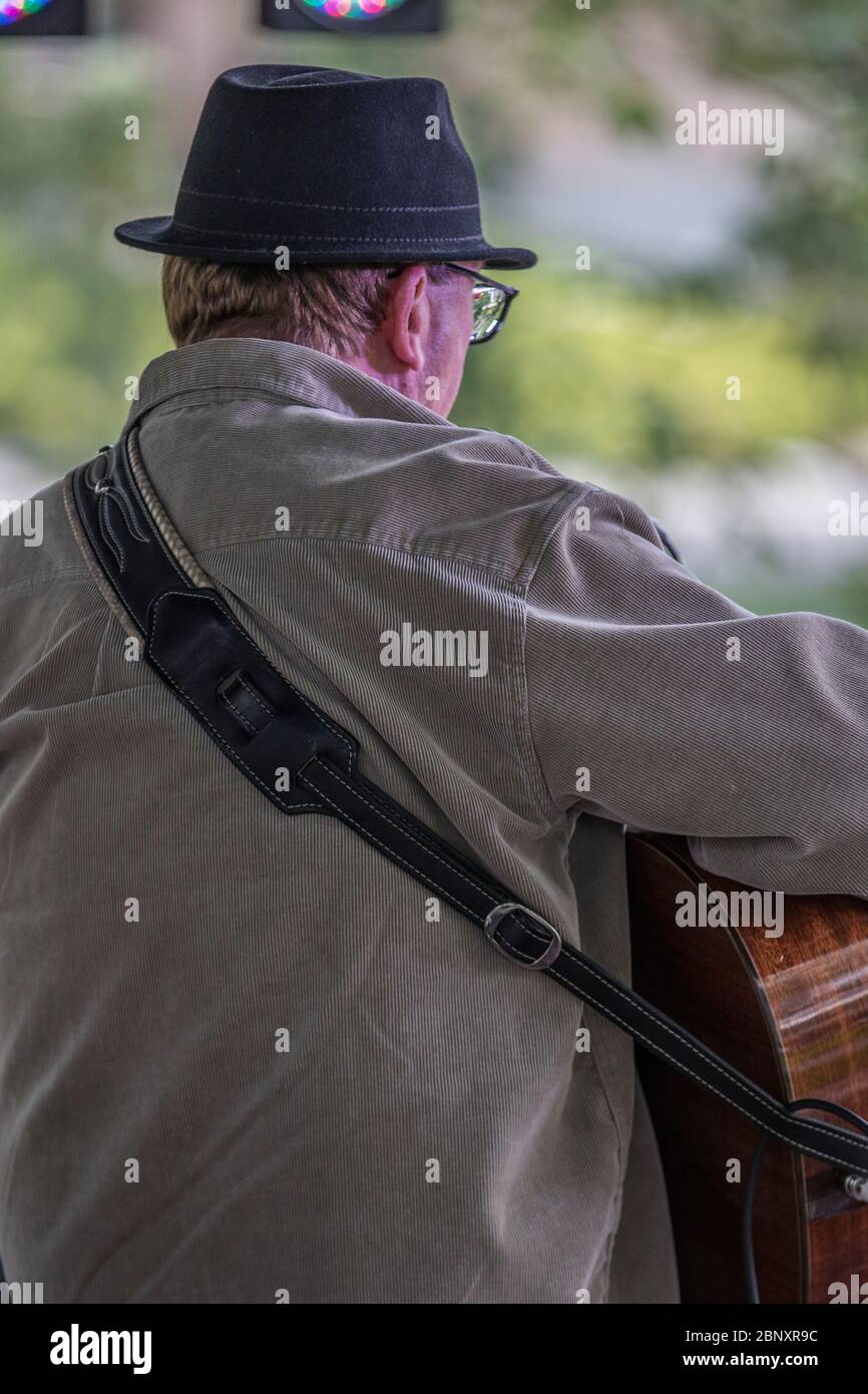 Folk singer performing at oudoor concert. Singing and playing guitar ...