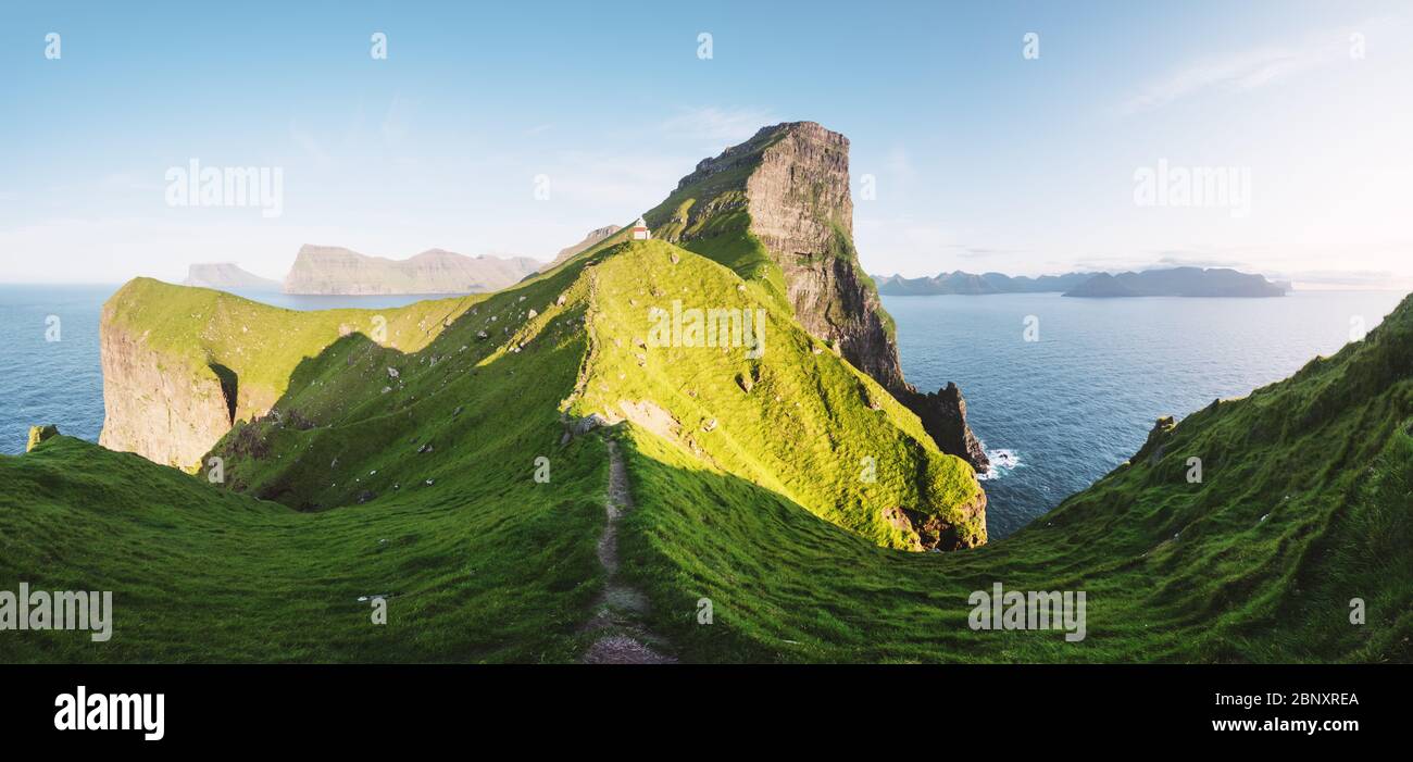 Panorama of green faroese hills and Kallur lighthouse on Kalsoy island ...