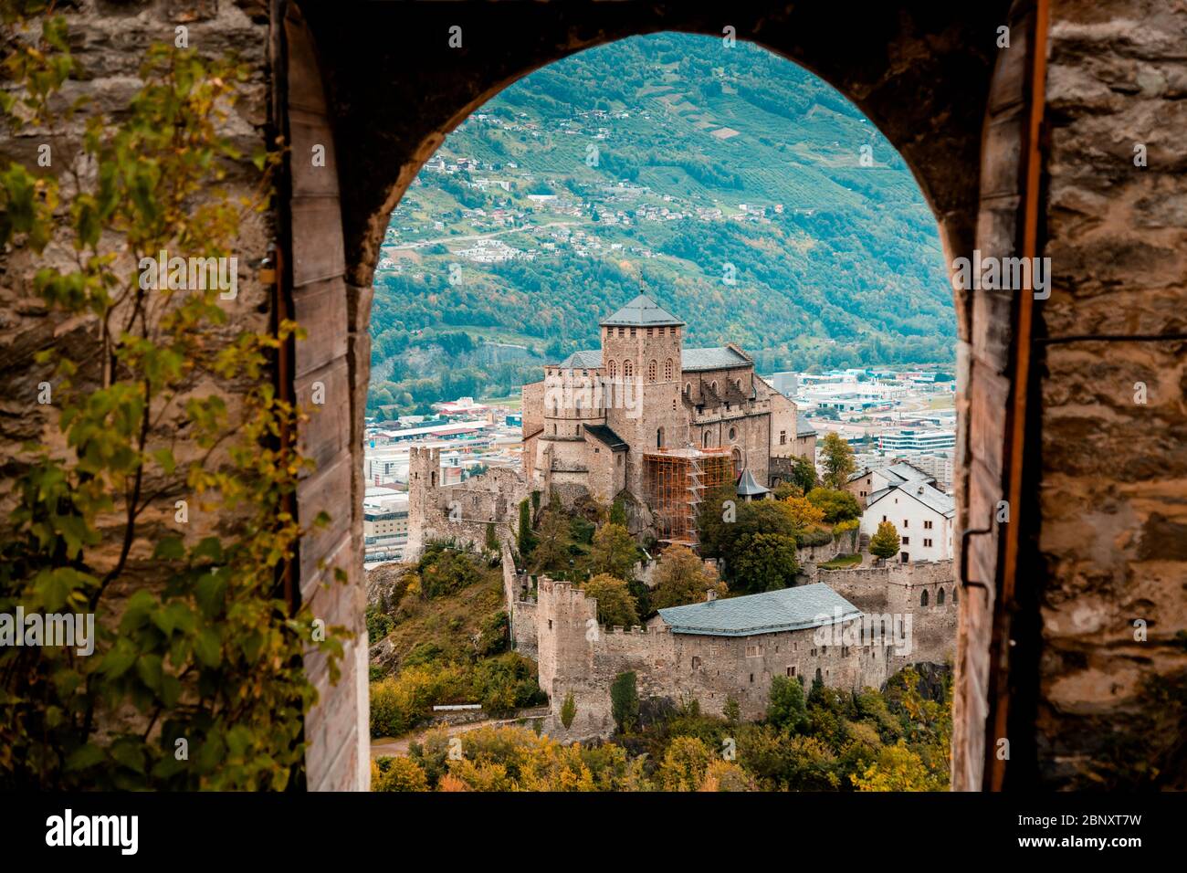 Medieval Valere basilica seen through main gates of Tourbillon Castle ...