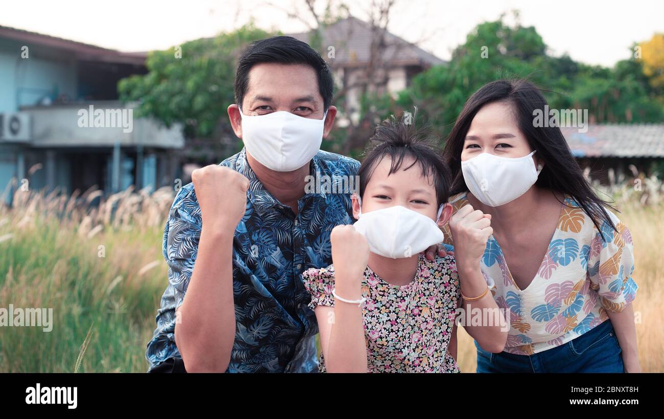 Power of family with father mother and daughter wearing medical face ...