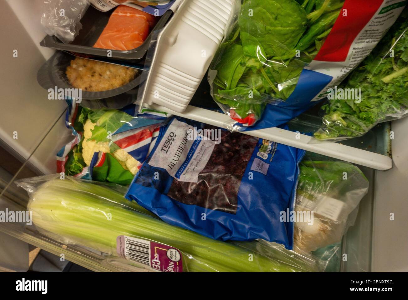 tightly packed small fridge with healthy food Stock Photo - Alamy