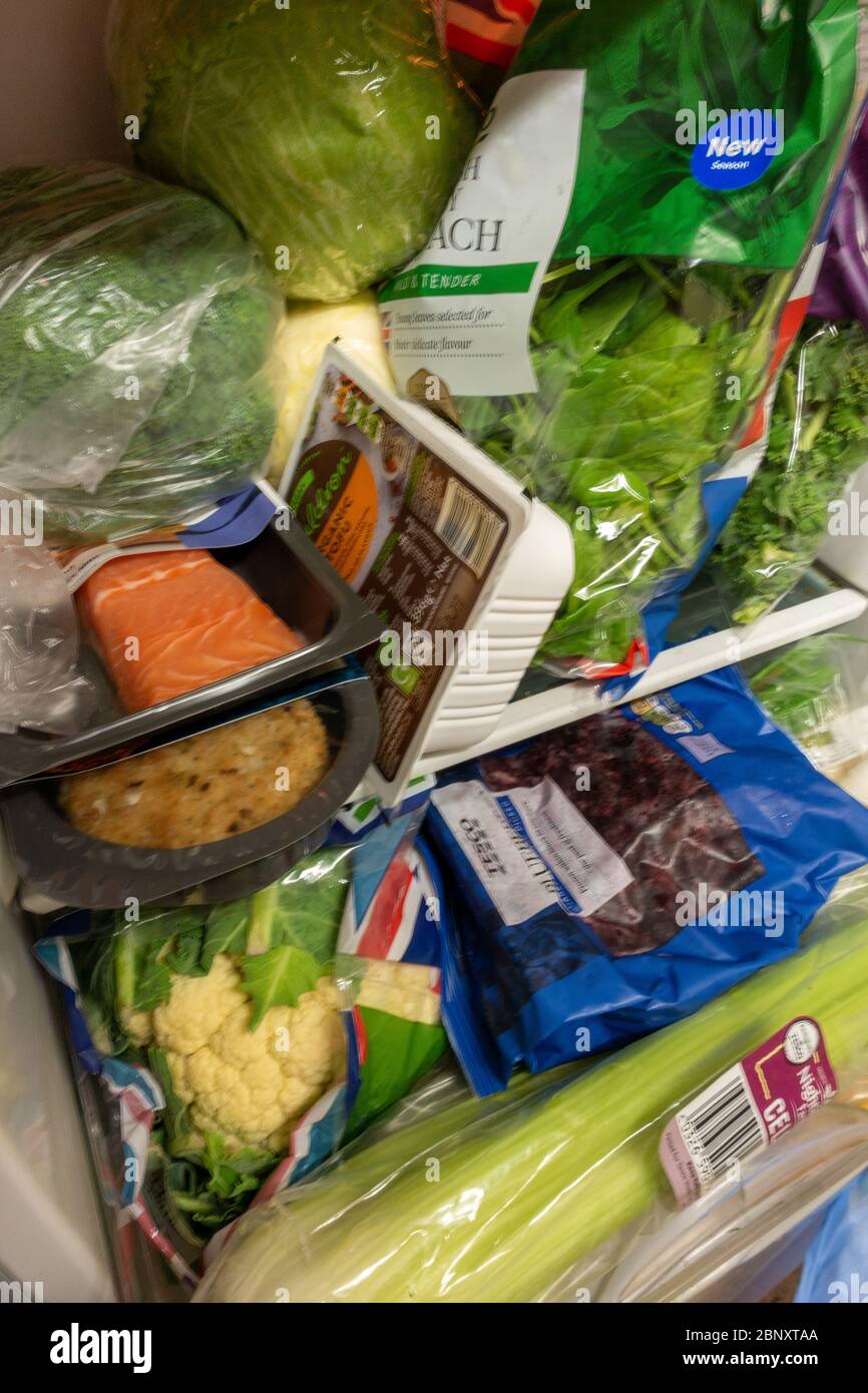 tightly packed small fridge with healthy food Stock Photo - Alamy