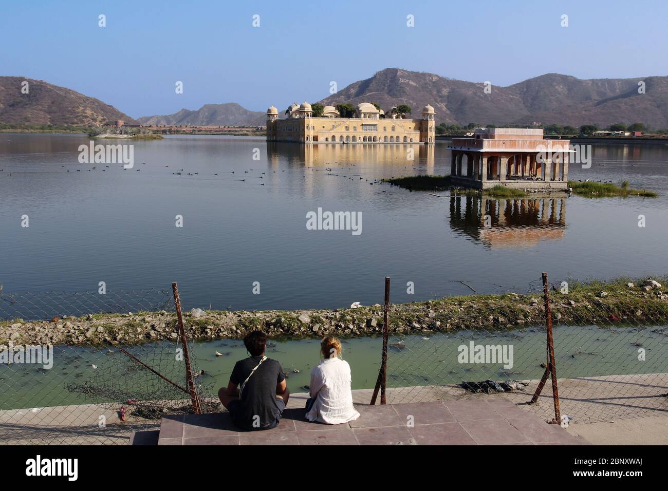 Couple of western tourists contemplating famous palace on the lake in ...