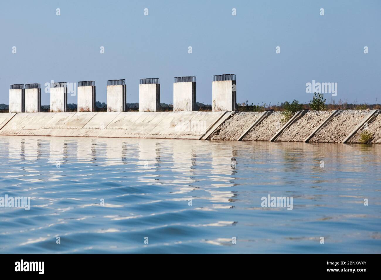 Coastal protective structure made of white concrete blocks. Danube ...