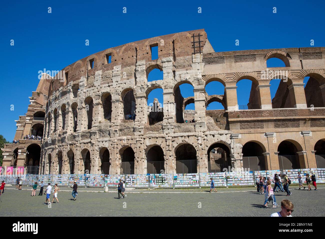 The Colosseum in Rome, ancient amphitheatre structure on a blue sky ...