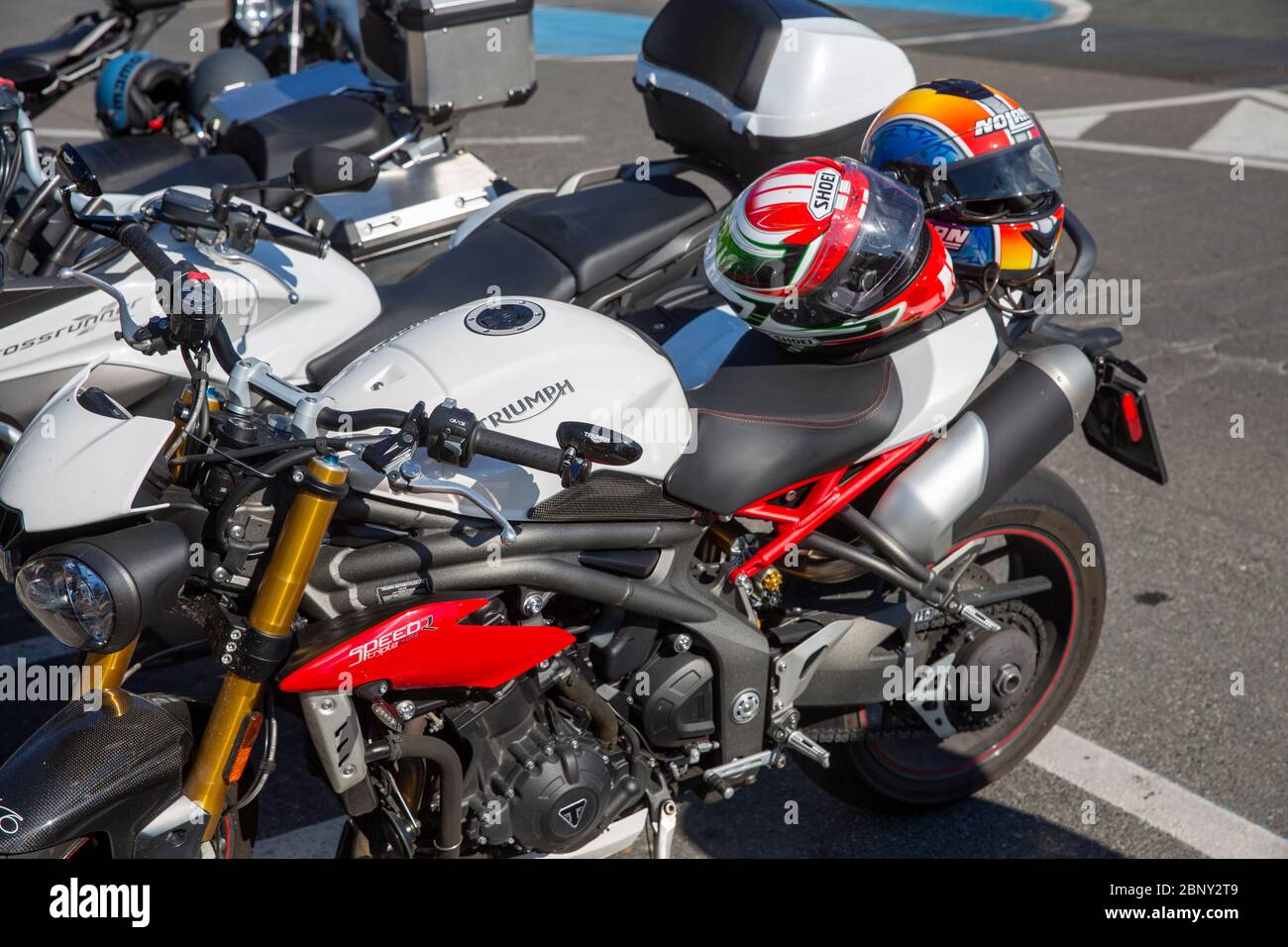 Triumph speed triple motorbike with bike helmets parked in the italian ...