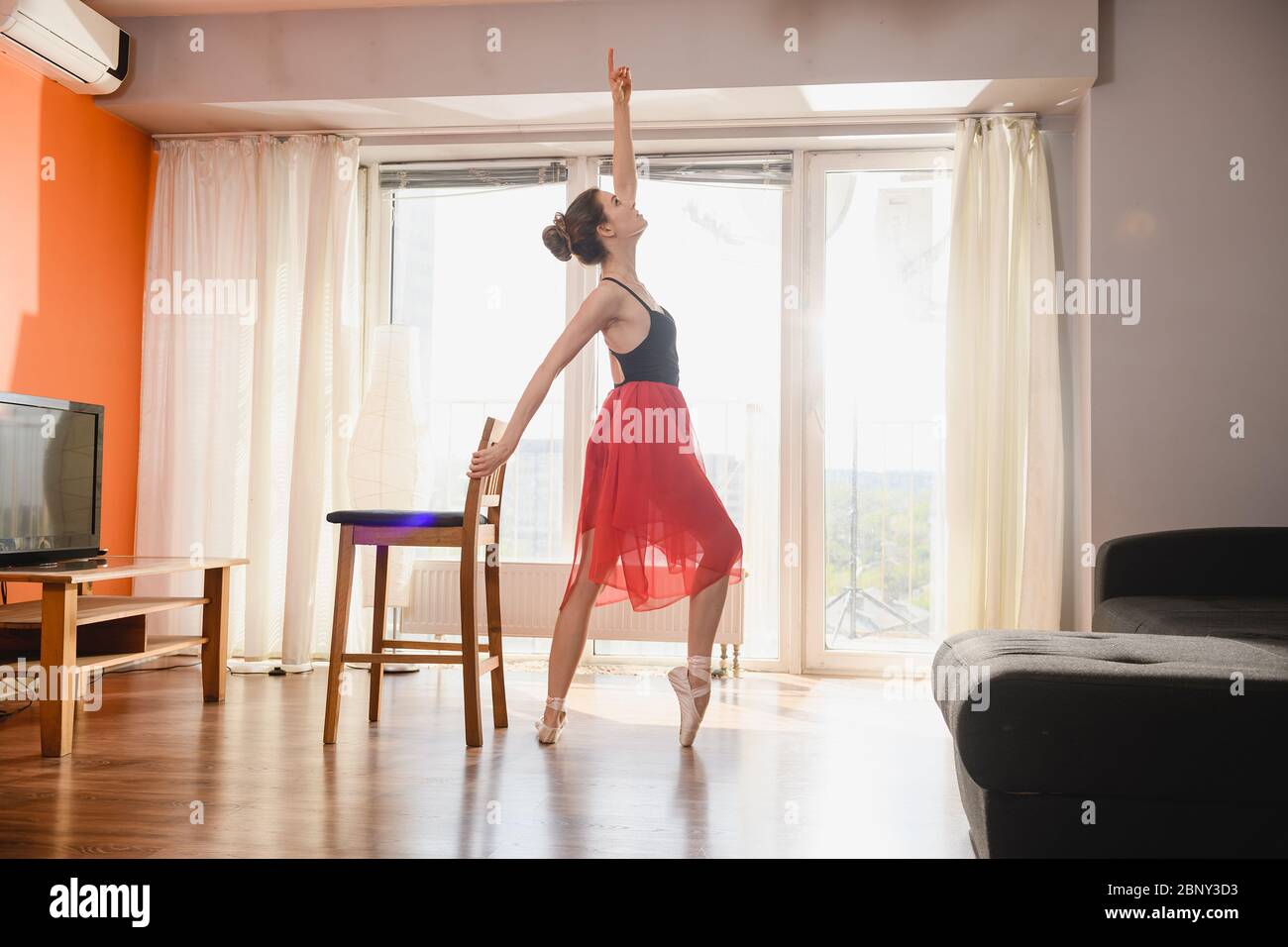 Beautiful ballerina dance with chair at home Stock Photo - Alamy