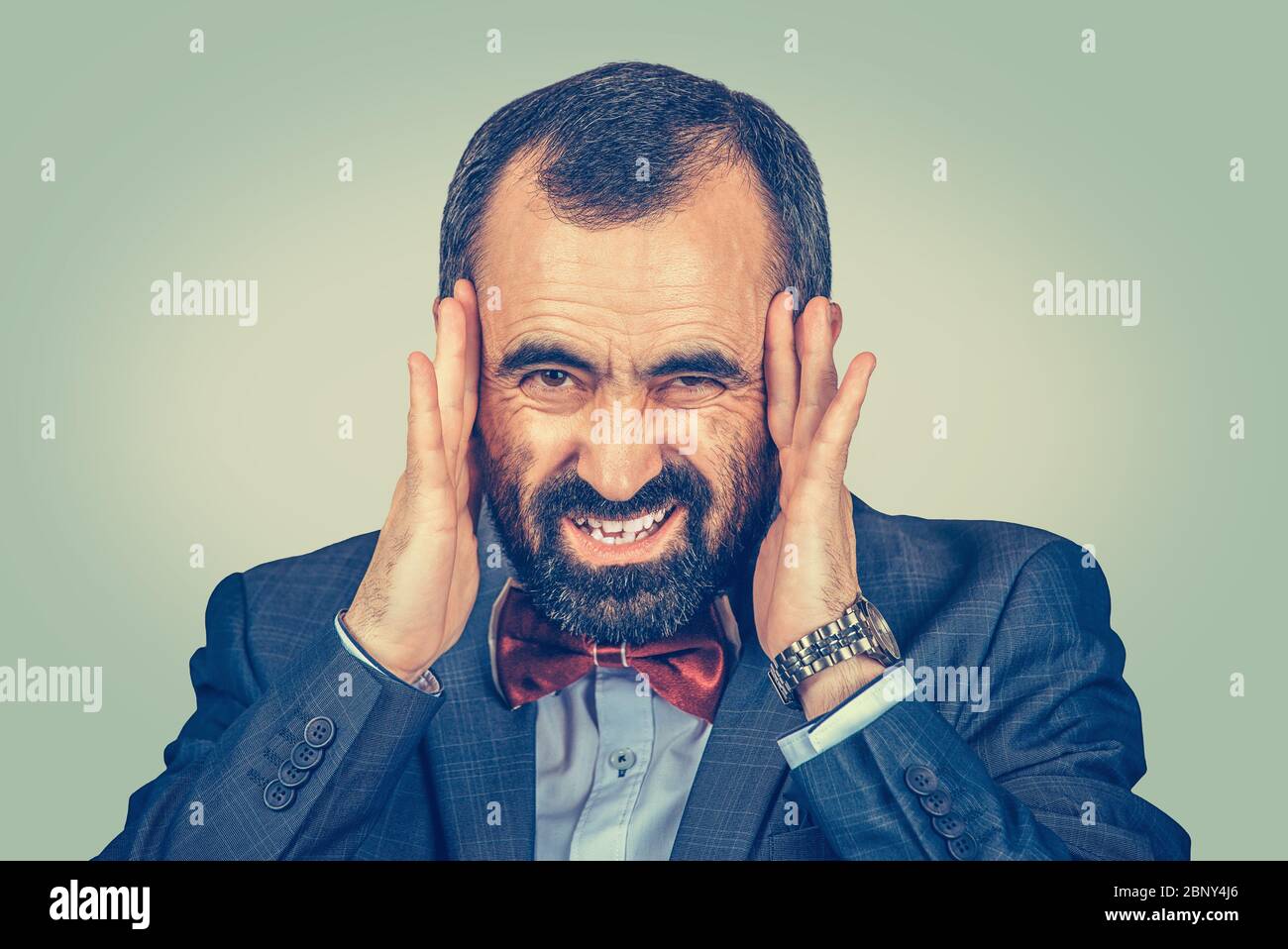 businessman having headache, holding hands on head in frustration ...