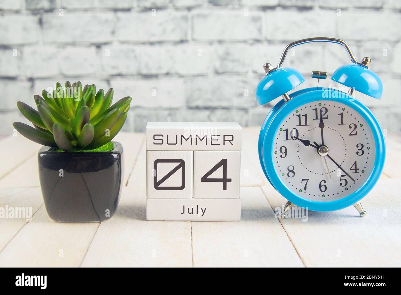 July 4 on the wooden calendar.The fourth day of the summer month, a ...