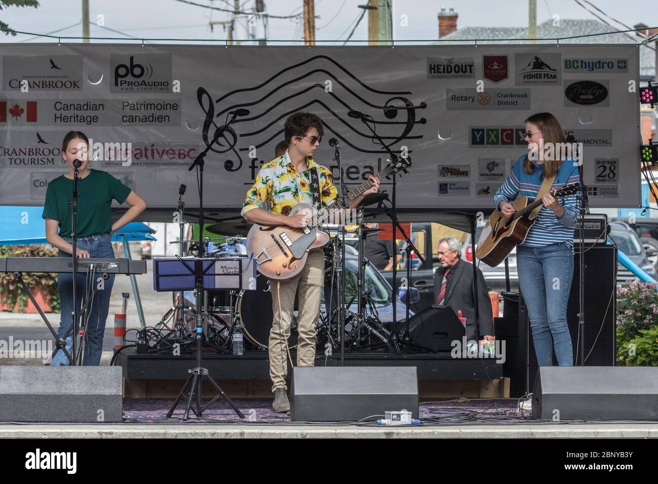 Family band of two sisters and a brother, plaaying in outdoor rock ...