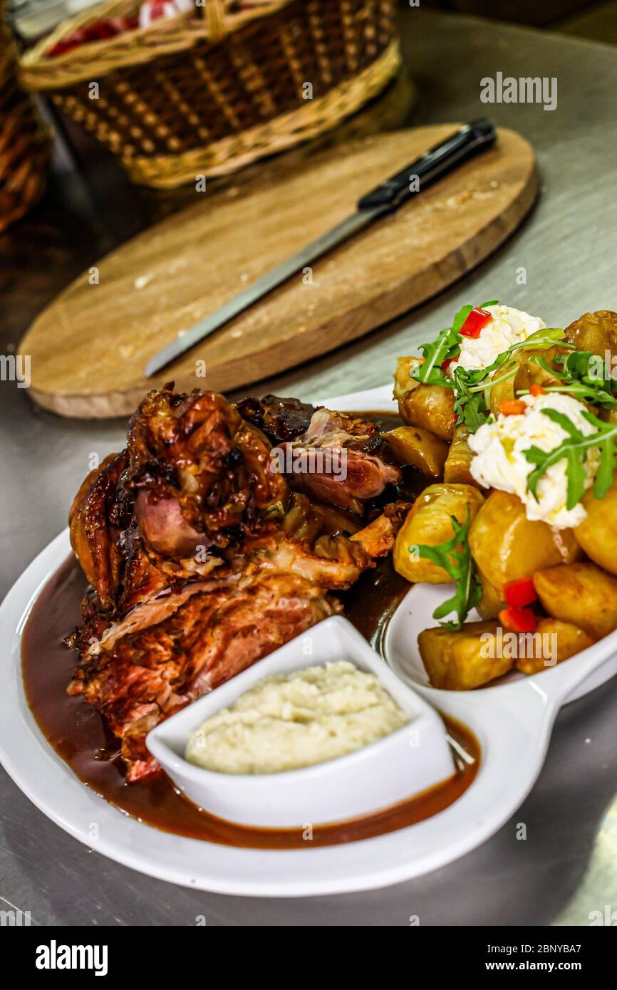 Roasted Pork Knuckle with succulent sauce, kaymak and vegetables Stock ...