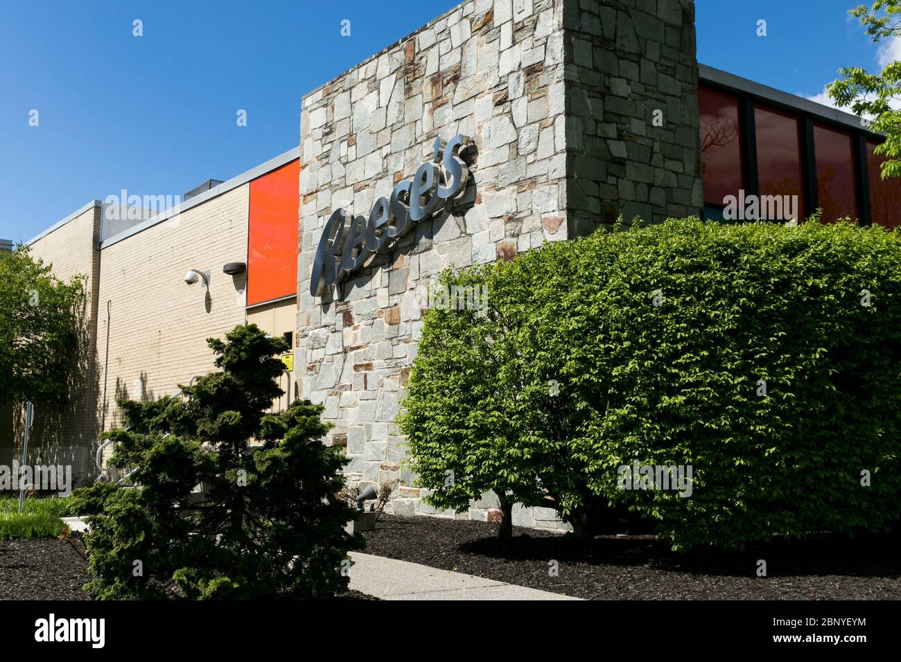 A logo sign outside of a facility that manufactures Reese's chocolate ...