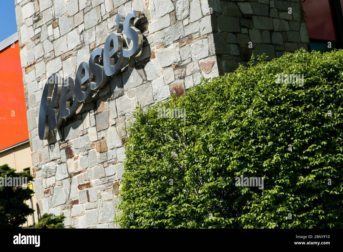 A logo sign outside of a facility that manufactures Reese's chocolate ...