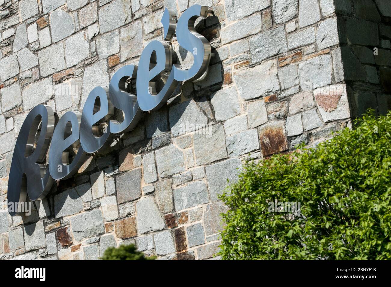 A logo sign outside of a facility that manufactures Reese's chocolate ...