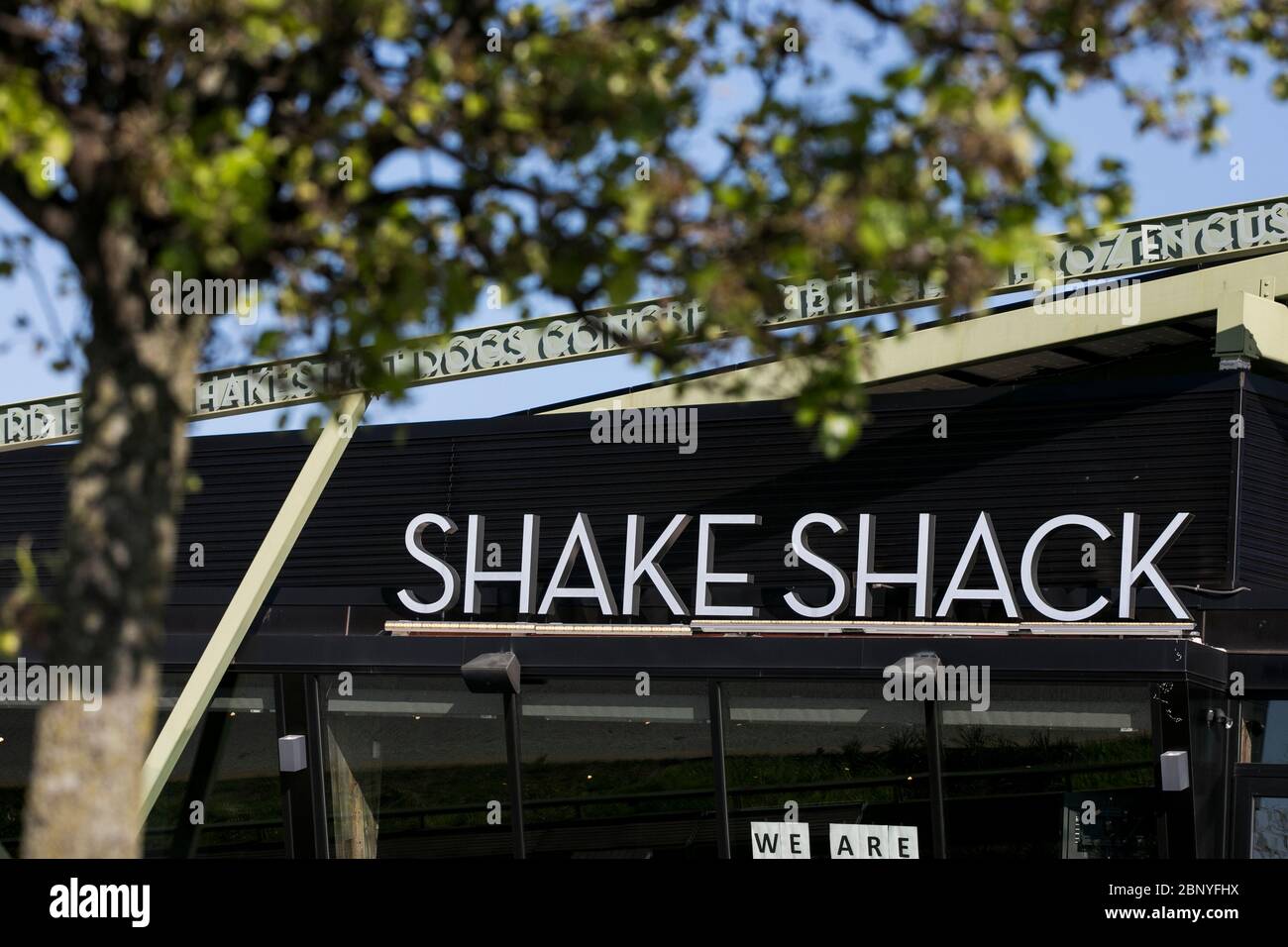 A logo sign outside of a Shake Shack restaurant location in King of ...