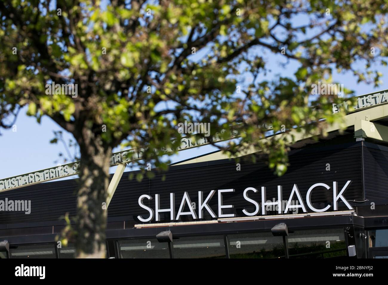 A logo sign outside of a Shake Shack restaurant location in King of ...