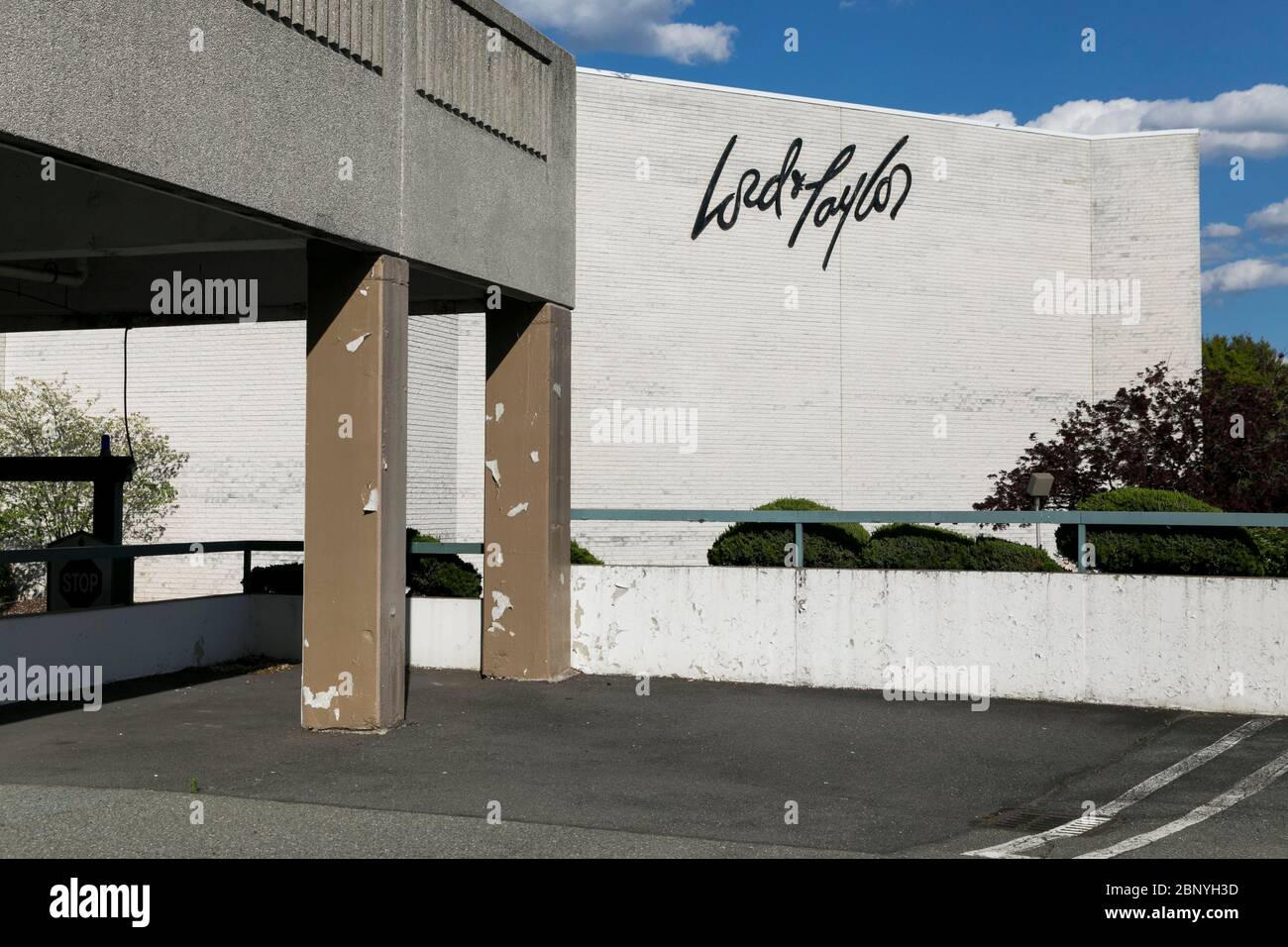 A logo sign outside of a Lord & Taylor department store location in ...