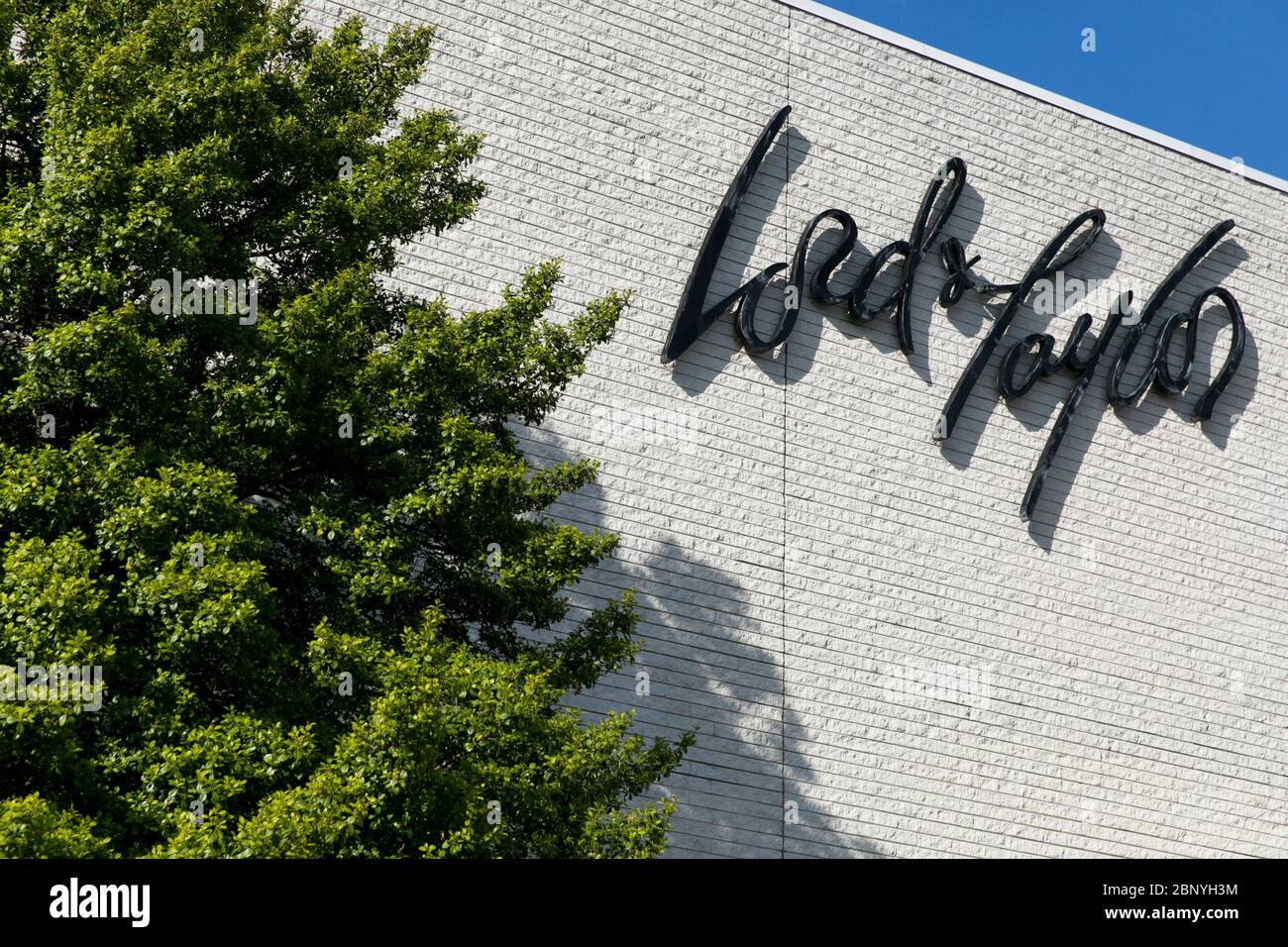 A logo sign outside of a Lord & Taylor department store location in ...