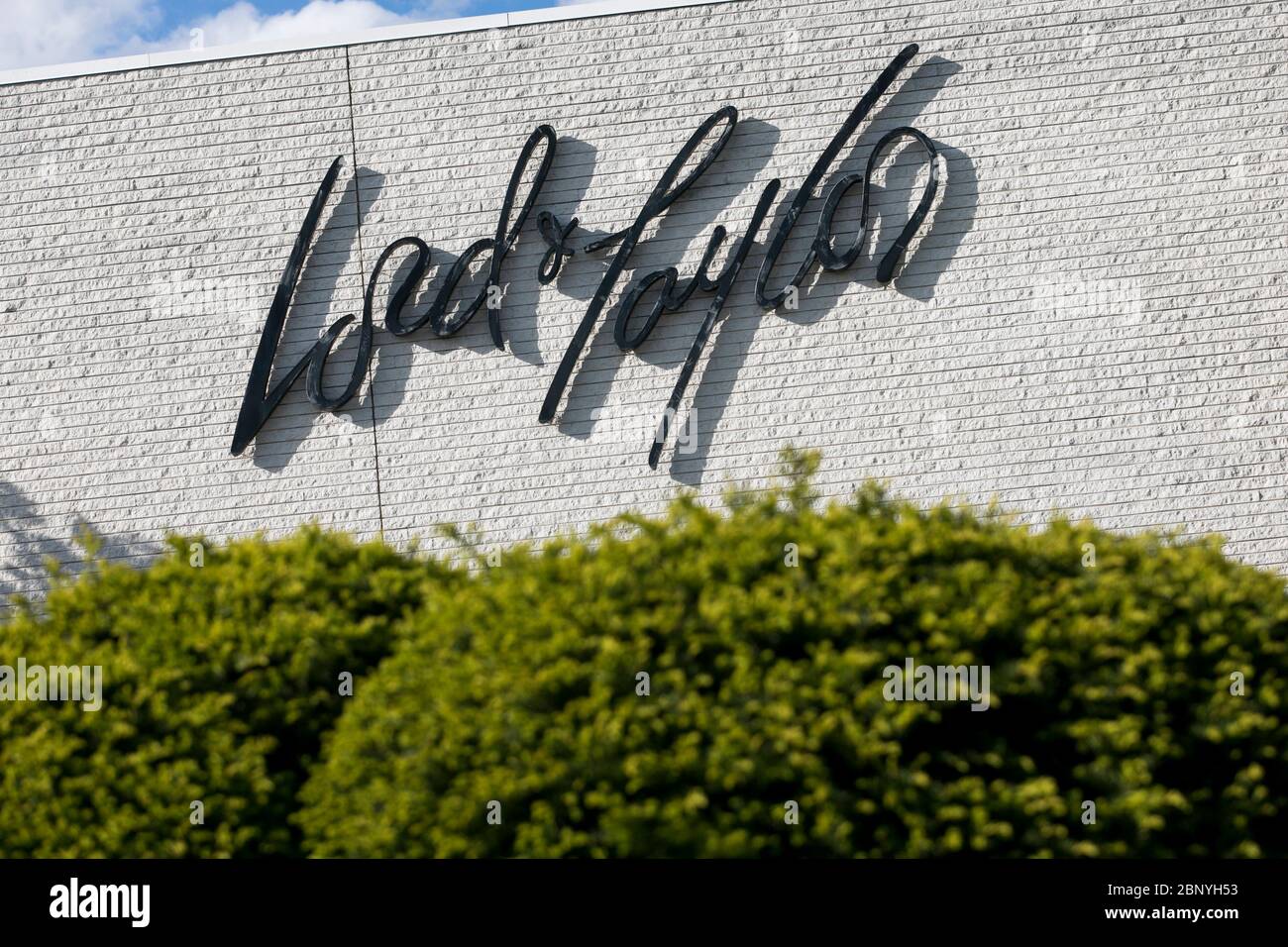 A logo sign outside of a Lord & Taylor department store location in ...
