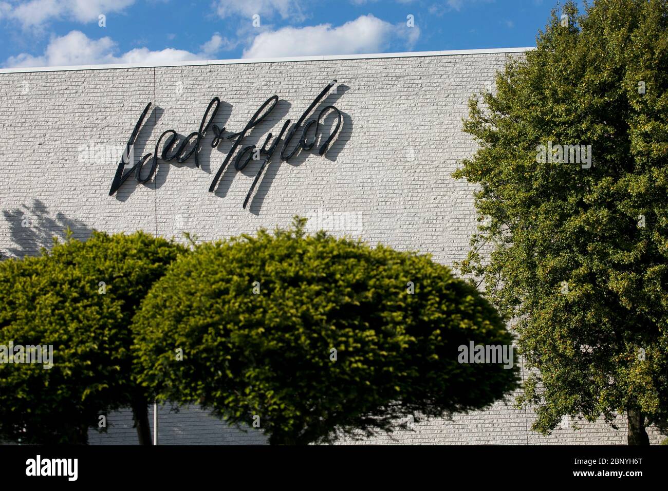 A logo sign outside of a Lord & Taylor department store location in ...