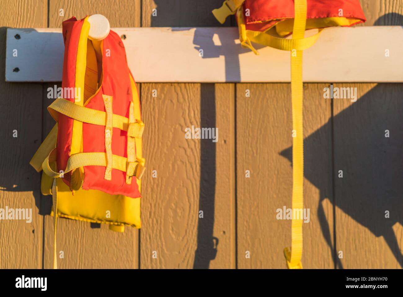 life jacket hang on the wall with sunset and copy space Stock Photo - Alamy