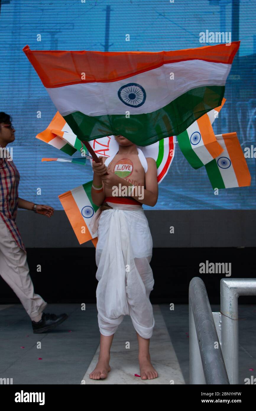 Indian kid waving the national flag at the stage Stock Photo - Alamy