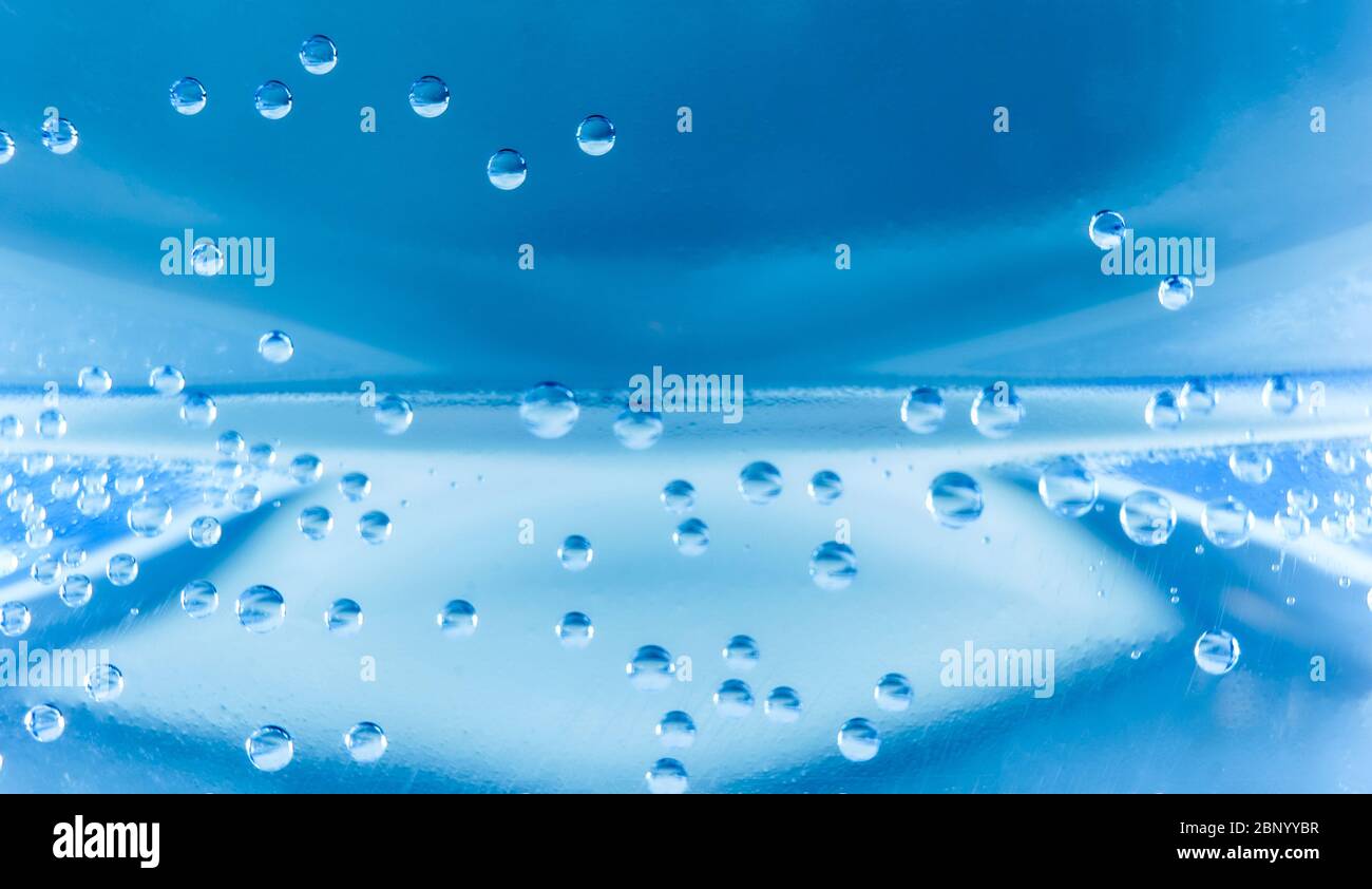 Macro shot of water with bubbles inside a plastic bottle with light and ...