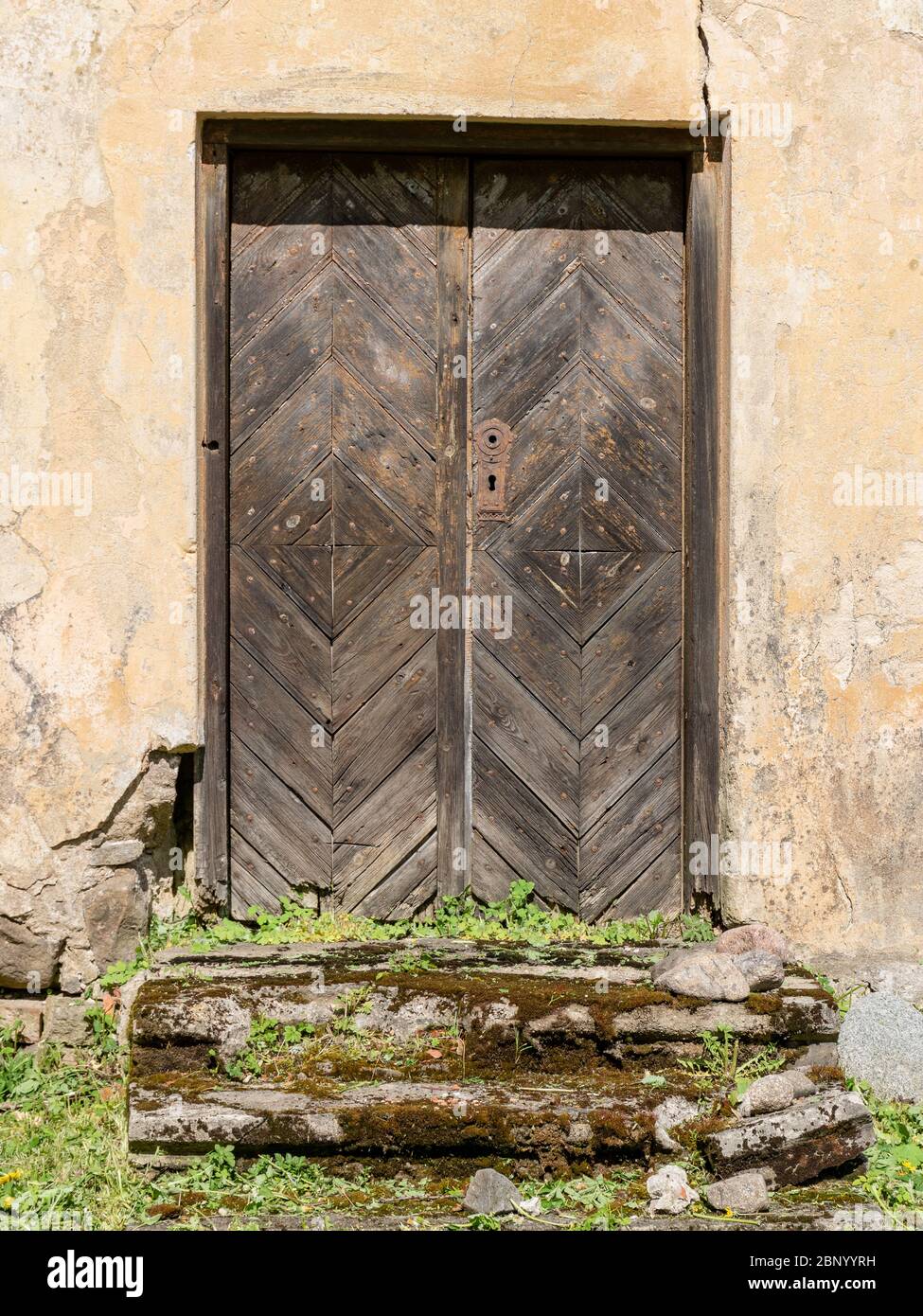 picture with an old wooden door in the wall of an old manor house Stock ...