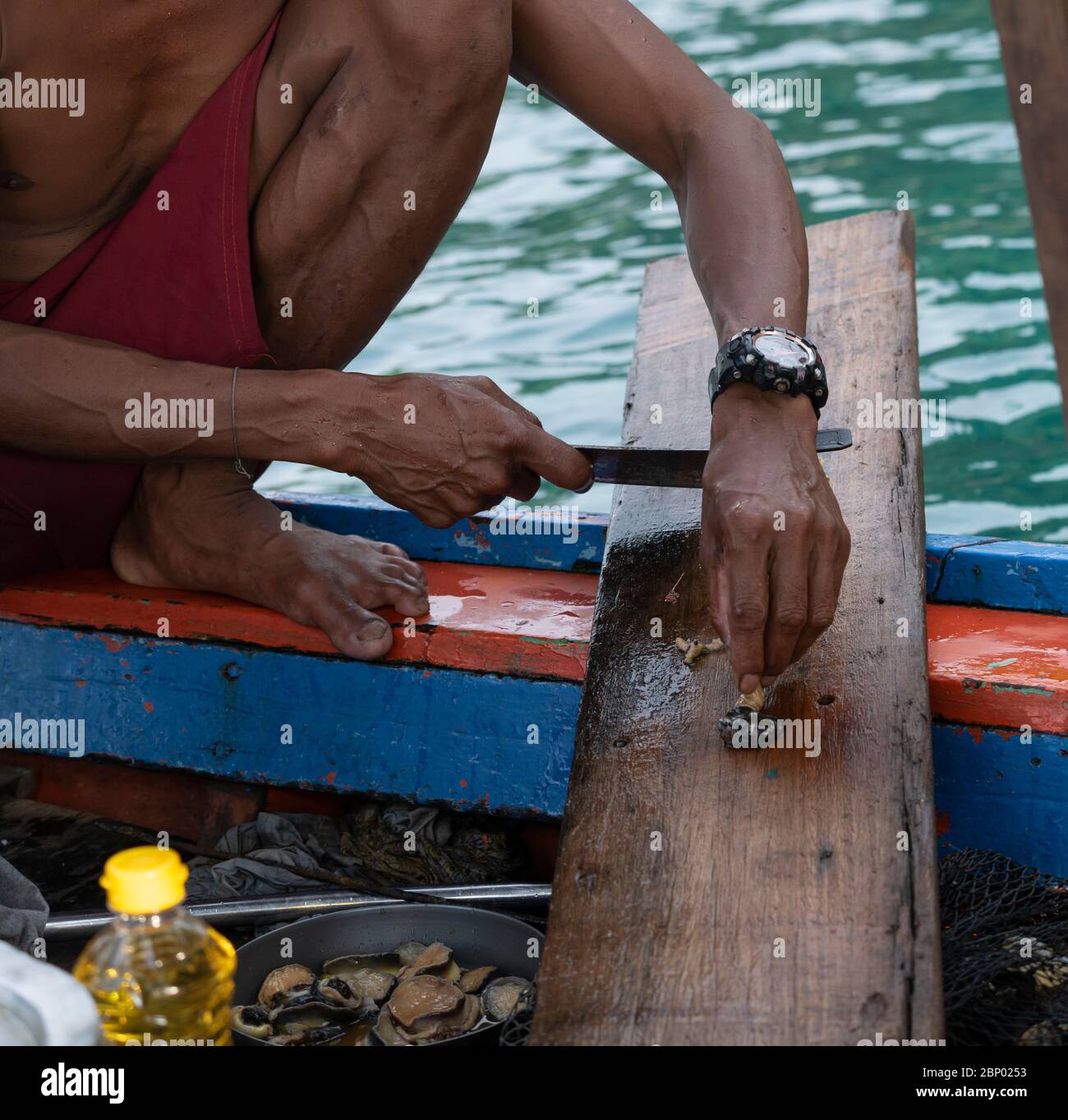 Indigenous people cooking fresh seafood on boat Stock Photo - Alamy