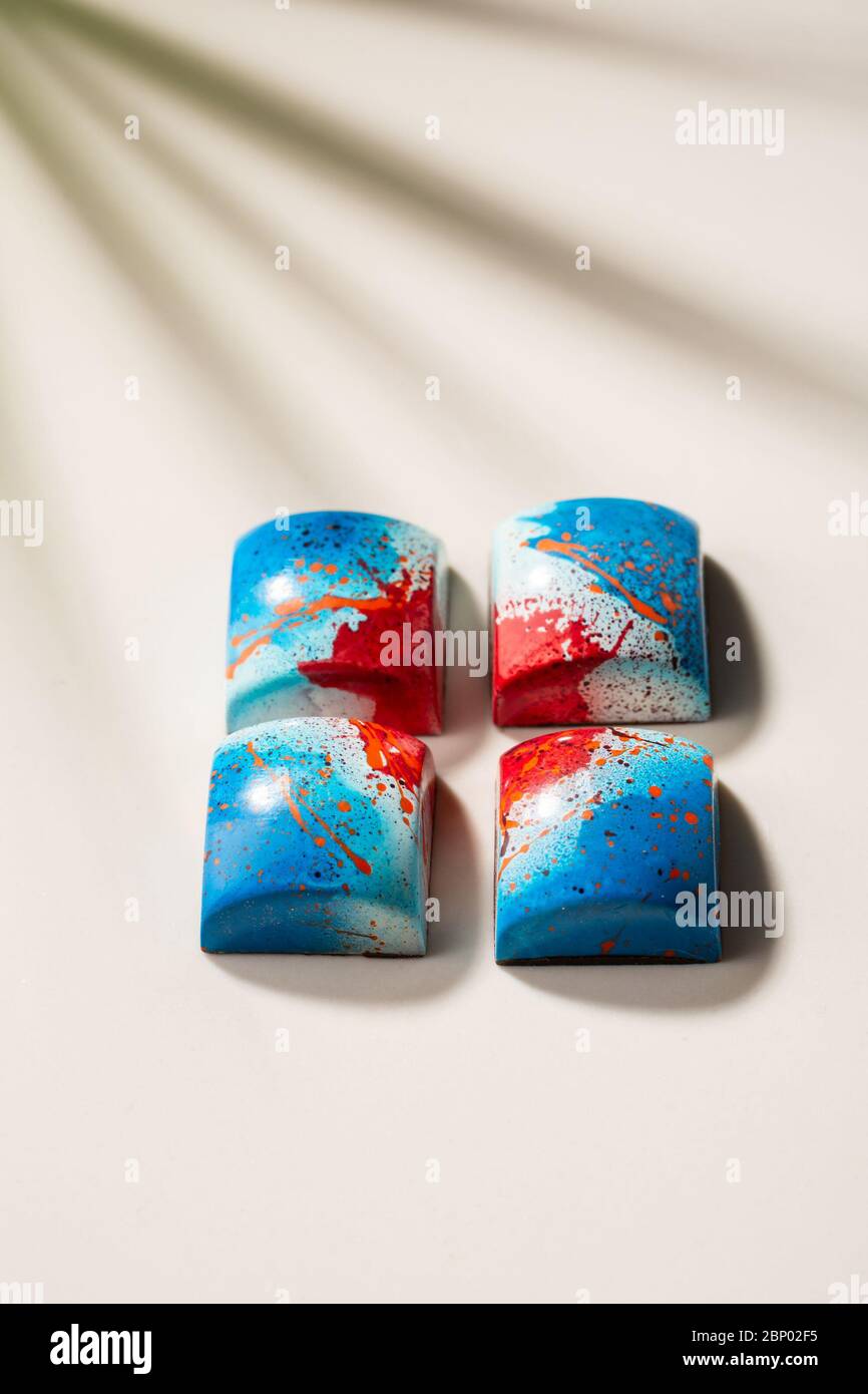 Chocolate candies set and plant shadow Stock Photo - Alamy