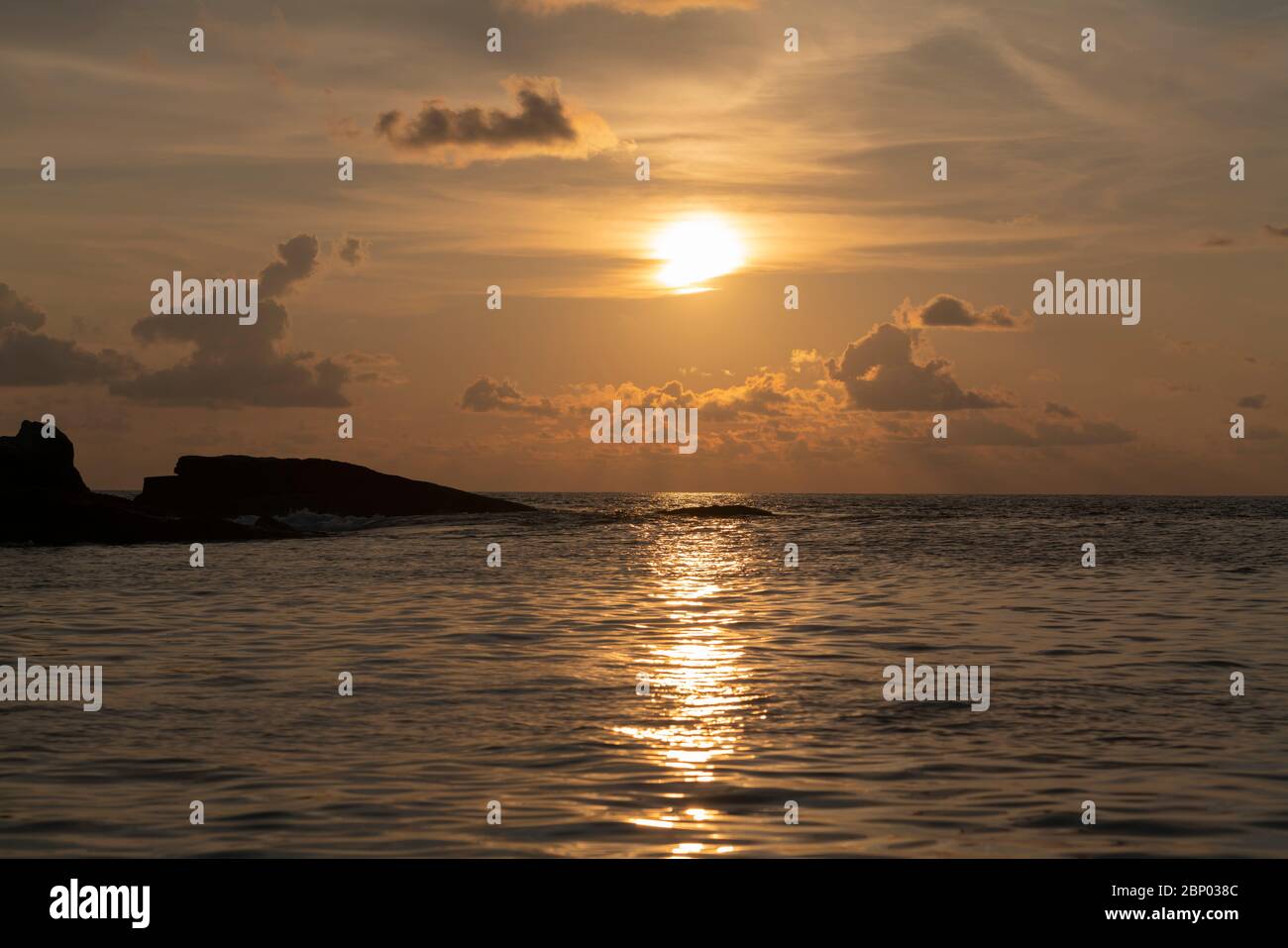 Golden sunset in the middle of the sea Stock Photo - Alamy