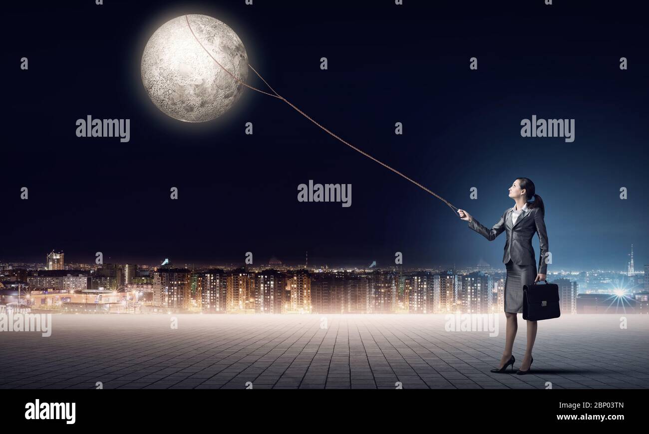 Woman catch moon Stock Photo - Alamy