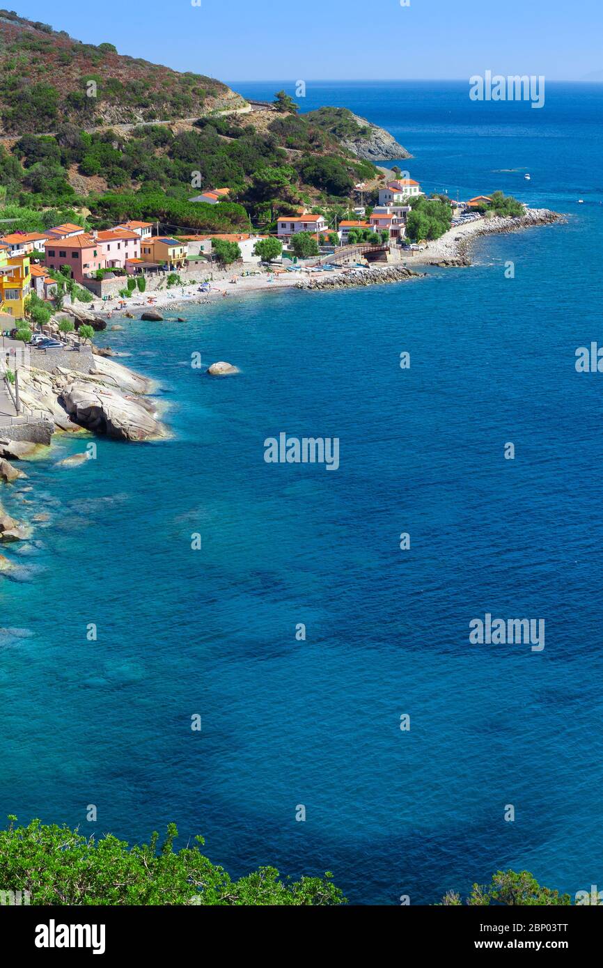 Sea shore with beach and rocks and rocky slope of the Island of Elba in ...