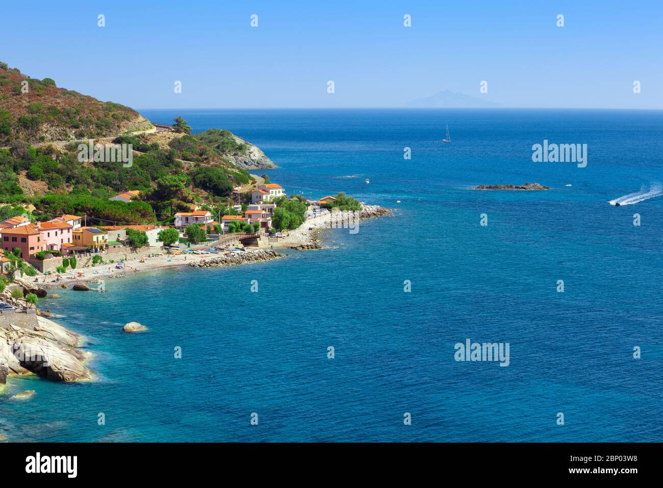 Sea shore with beach and rocks and rocky slope of the Island of Elba in ...